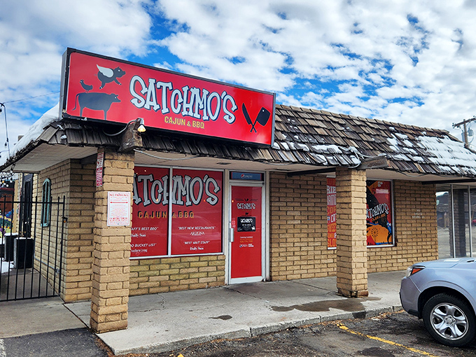 Satchmo's vibrant red exterior beckons like a culinary lighthouse, promising Cajun treasures within its unassuming brick walls.