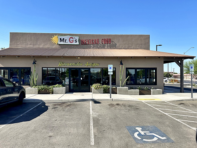 The sun-kissed facade of Mr. G's welcomes hungry visitors with its "Bienvenidos Amigos" greeting and desert-appropriate cacti standing guard.