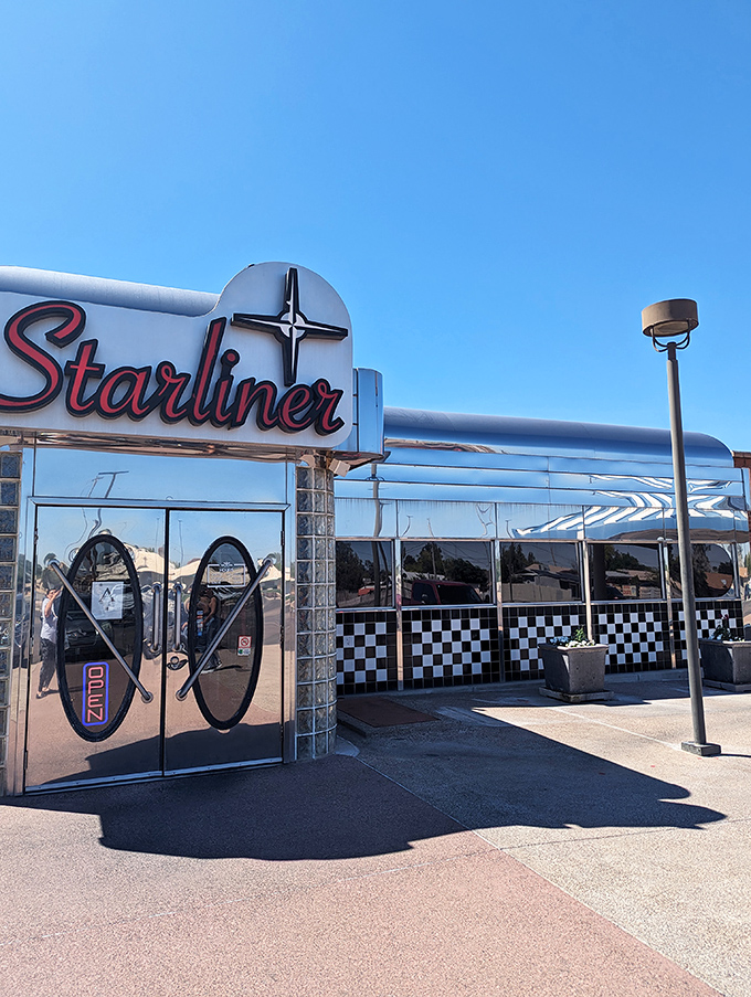 The gleaming silver exterior of Starliner Diner catches Arizona sunlight like a time machine waiting to transport hungry travelers back to simpler times.