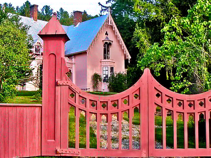 The salmon-pink gate welcomes visitors to Morrill's Gothic fantasy, standing guard like a portal to Victorian Vermont.