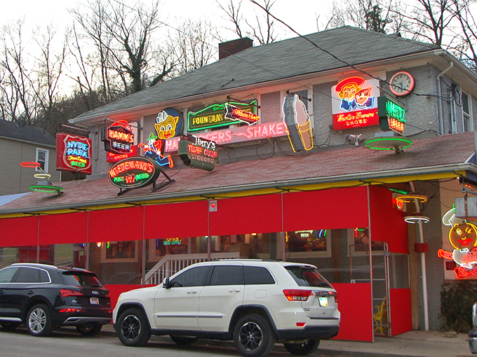 Neon paradise! The Turf Club's facade glows like a carnival of vintage signs, beckoning hungry travelers with promises of comfort food glory.