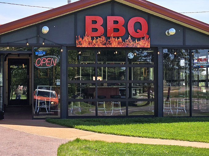 The fiery red BBQ sign beckons like a smoky lighthouse, guiding hungry travelers to this Wautoma treasure.