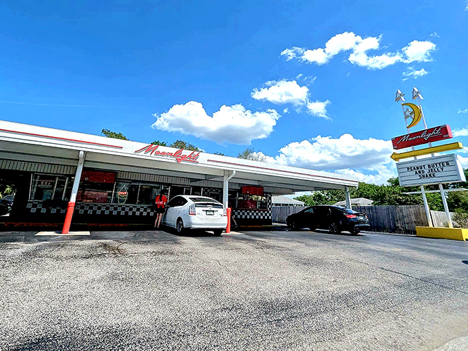 The iconic Moonlight Drive-In exterior beckons with its retro signage and promise of classic American comfort food that transcends time.