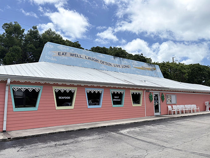 The cheerful pink exterior of Mrs. Mac's Kitchen promises Florida Keys charm with its "EAT WELL, LAUGH OFTEN, LIVE LONG" philosophy proudly displayed.