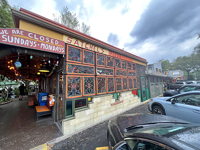 Satchel's vibrant facade welcomes pizza pilgrims with stained glass windows and a cheerful "CLOSED SUNDAYS&bull;MONDAYS" reminder. Even paradise needs weekends!