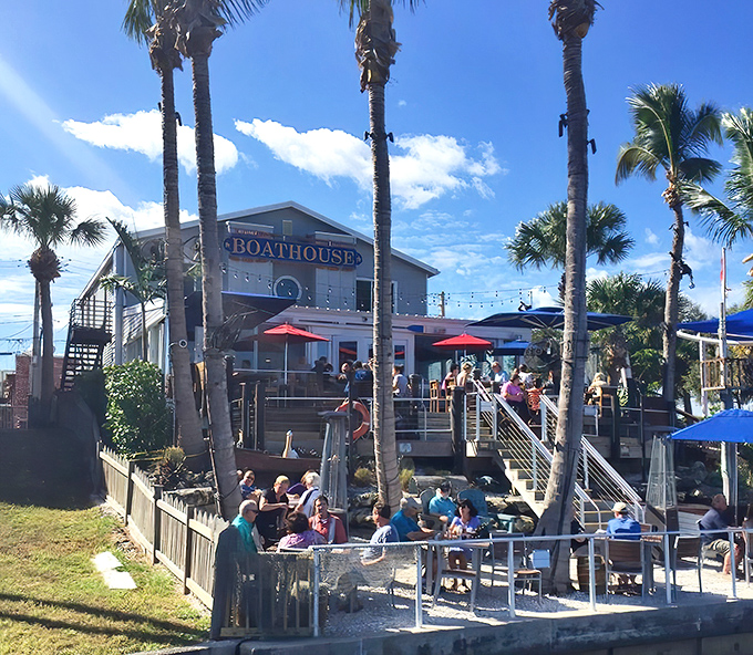Stuart Boathouse rises from the waterfront like a coastal dream, palm trees standing guard over this culinary treasure.