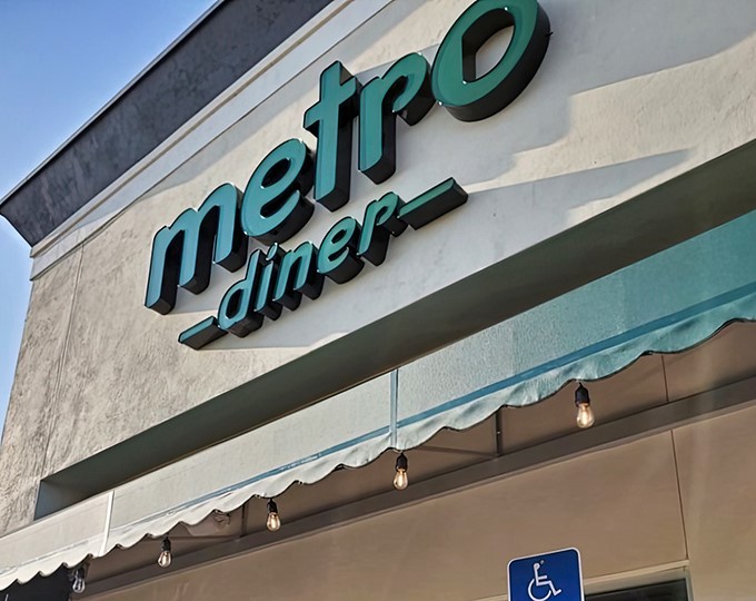 The teal Metro Diner sign beckons hungry patrons like a breakfast lighthouse guiding ships to delicious shores.
