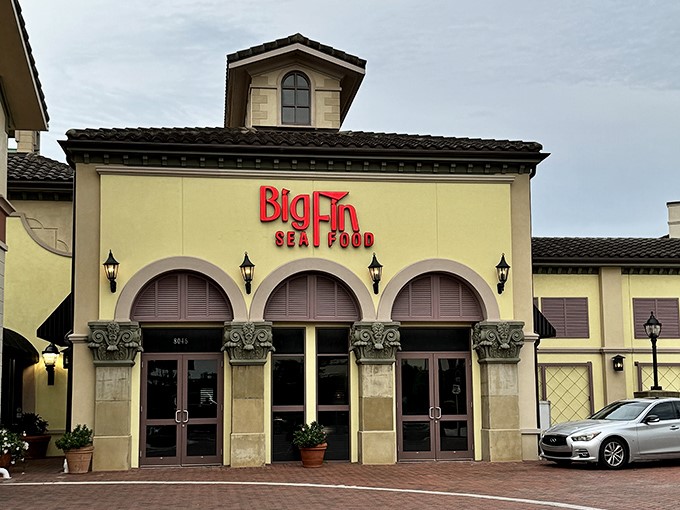 The Mediterranean-inspired façade of Big Fin Seafood Kitchen stands proudly on Restaurant Row, promising oceanic delights within its welcoming doors.