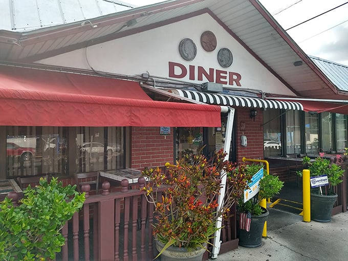 The iconic red awning and "DINER" sign promise comfort food paradise &ndash; no fancy frills, just honest-to-goodness deliciousness waiting inside.