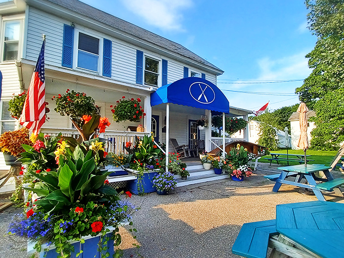 A storybook Vermont welcome awaits at this flower-adorned white clapboard house, where blue shutters hint at the culinary magic happening inside.