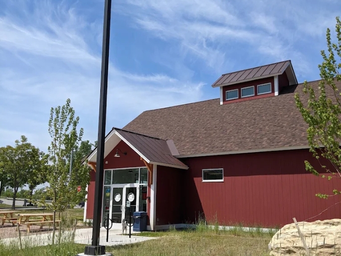 The charming red barn exterior of Putney Road Deli stands like a beacon for sandwich lovers, promising country store charm with culinary prowess inside.