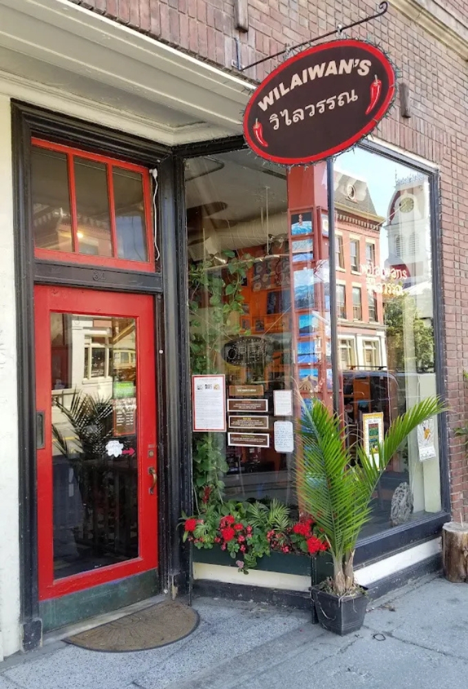The vibrant red door and circular "Wilaiwan's" sign beckon hungry passersby like a culinary lighthouse on Montpelier's Barre Street.