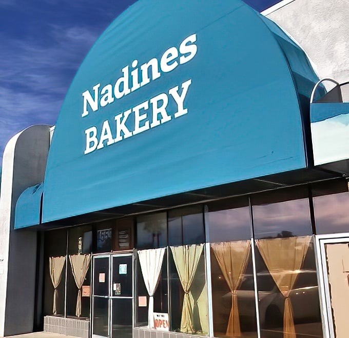 The iconic turquoise awning of Nadine's Bakery stands out against the Tucson sky, a beacon for dessert lovers seeking authentic baked goodness.