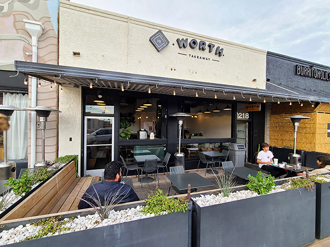 The unassuming storefront belies culinary treasures within &ndash; Worth Takeaway's clean lines and inviting patio beckon hungry passersby.