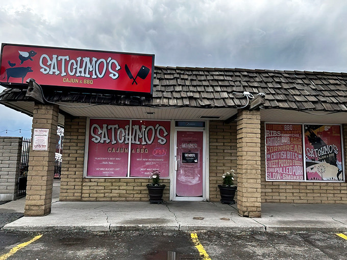 The vibrant red Satchmo's sign beckons hungry travelers like a culinary lighthouse in Flagstaff's brick-and-mortar landscape.