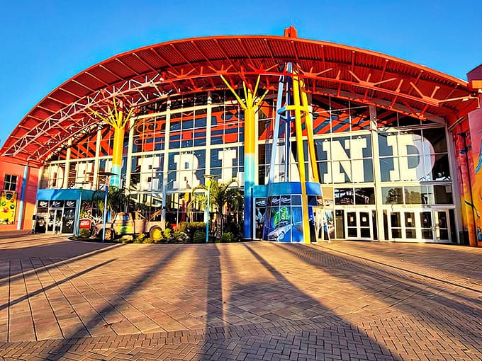 The vibrant entrance to Dezerland Park Orlando beckons with its bold red canopy and colorful columns – Florida fun that doesn't require sunscreen!