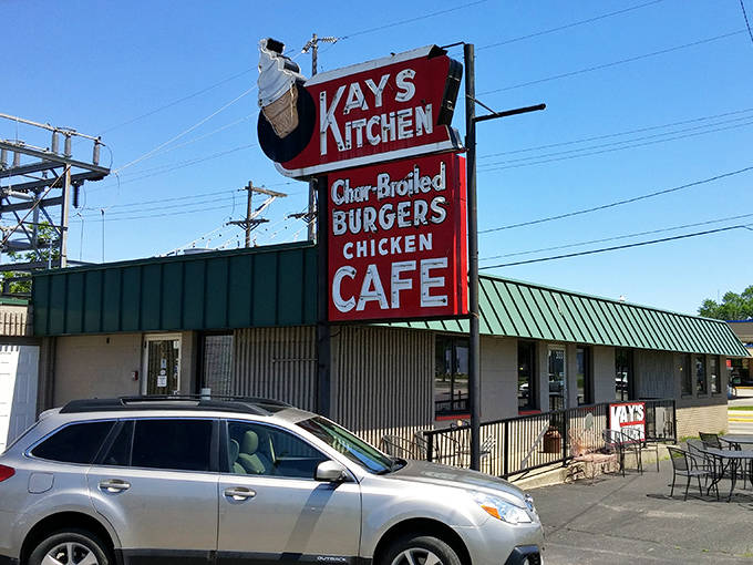 The iconic red sign of Kay's Kitchen stands tall against the Minnesota sky, promising char-broiled burgers and homemade goodness to weary travelers.
