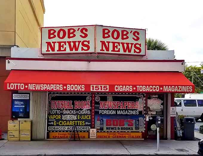 The iconic red awning of Bob's News & Books stands as a defiant beacon of print culture on Las Olas Boulevard, promising literary treasures within.
