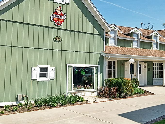 The charming green exterior of the Sock Monkey Museum in Long Grove, Illinois, where whimsy awaits behind every door.
