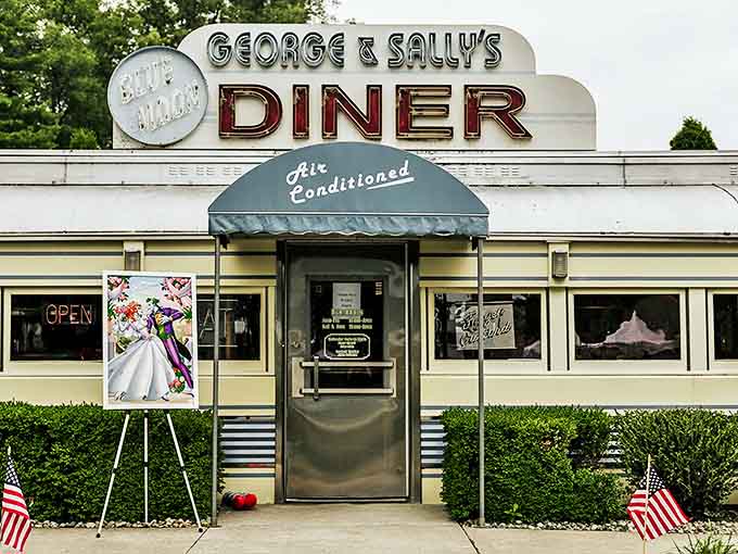 The gleaming cream and blue facade of George & Sally's Blue Moon Diner stands like a time capsule in Hickory Corners, complete with that iconic red "DINER" sign beckoning hungry travelers.