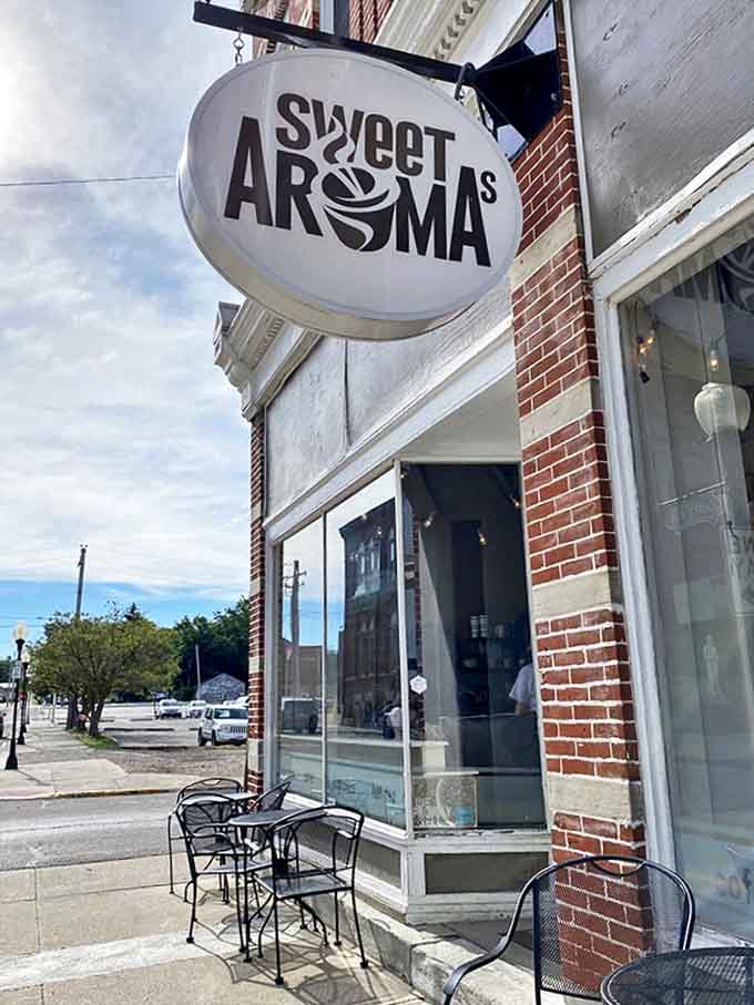 The iconic Sweet Aromas sign beckons coffee lovers like a caffeinated lighthouse on Bellefontaine's charming brick-lined street.