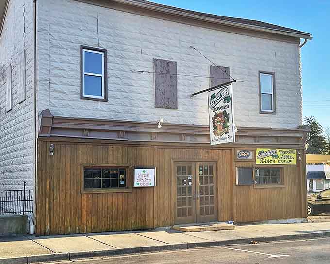 O'Riley's Tavern exterior stands unassumingly on Brookville's main street, its wooden facade hiding culinary treasures that locals have cherished for years.