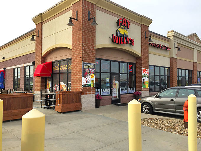 Fat Willy's exterior beckons hungry travelers with its cheerful red signage and inviting storefront &ndash; a roadside oasis in Rochester's dining landscape.