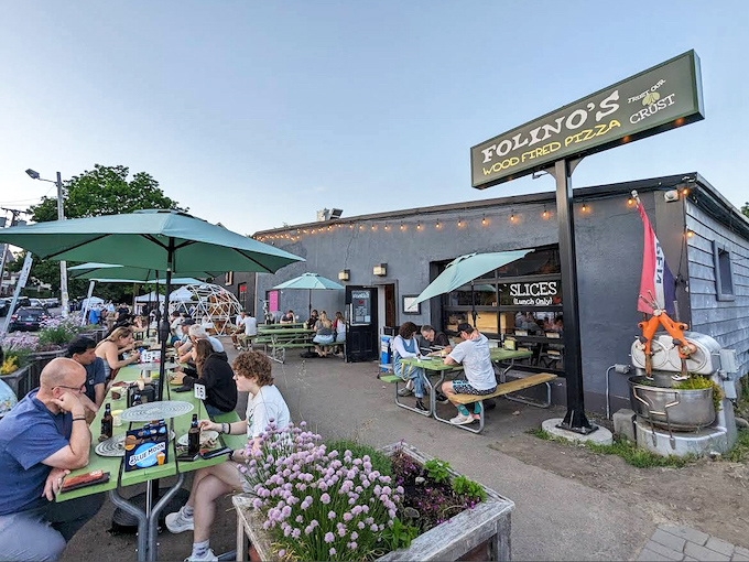 Folino's exterior welcomes pizza pilgrims with unpretentious charm and the promise of wood-fired wonders within. String lights add just the right touch of magic.