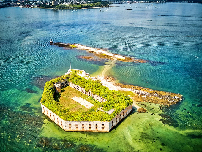 Fort Gorges rises from Casco Bay like a stone island, its hexagonal walls creating a perfect fortress silhouette against the blue Maine waters.