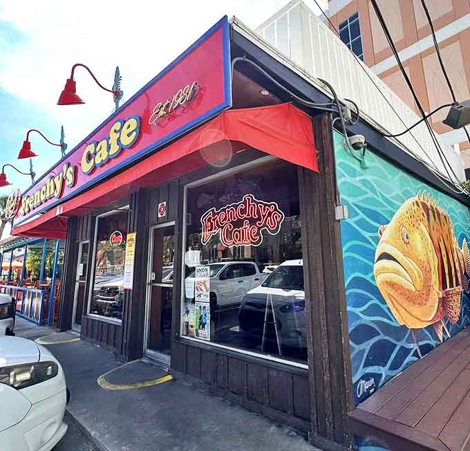The iconic red awning of Frenchy's Cafe beckons seafood lovers with its unpretentious charm and the promise of legendary grouper sandwiches.