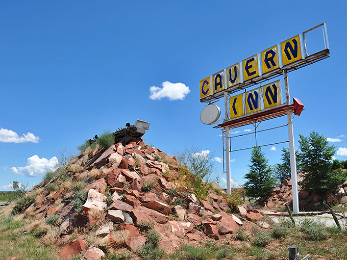 The iconic "CAVERN INN" sign stands against the Arizona sky, a vintage beacon promising underground wonders to Route 66 travelers.