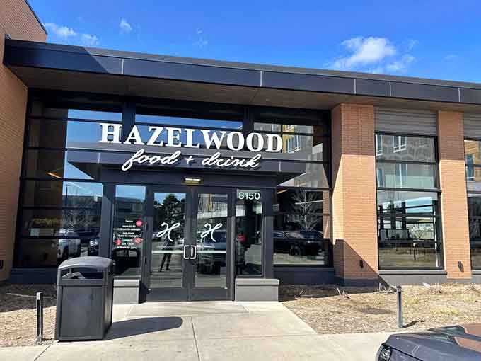 The modern exterior welcomes diners with clean lines and warm brick, promising good things await inside this Bloomington gem.