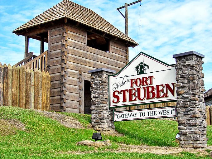 Historic Fort Steuben welcomes visitors with its imposing wooden watchtower and stone entrance sign &ndash; a portal to America's frontier past.