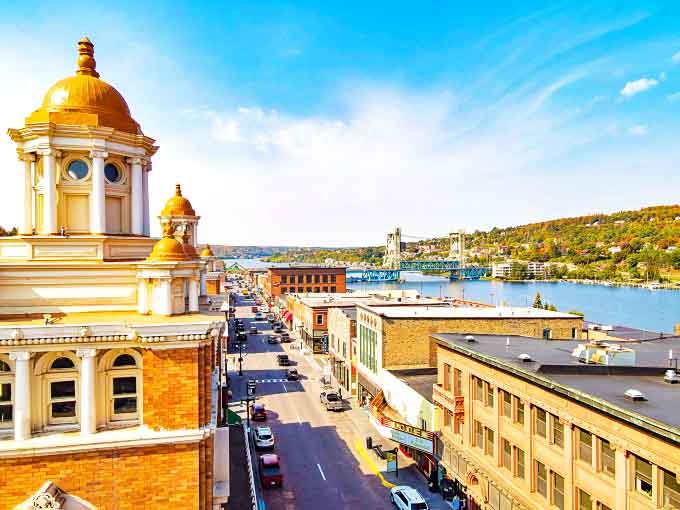 Houghton's golden-domed buildings stand proudly against Michigan's blue sky, creating a postcard-perfect scene that welcomes visitors to this Upper Peninsula gem.