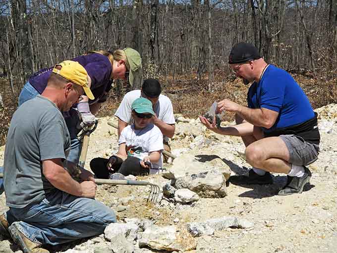 Nothing says "serious treasure hunting" quite like a group of adults crouched around a pile of rocks with the focus of surgeons performing delicate operations.