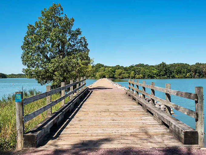 A wooden bridge stretches across Lake Shetek's calm waters, inviting adventurers to cross into nature's embrace.