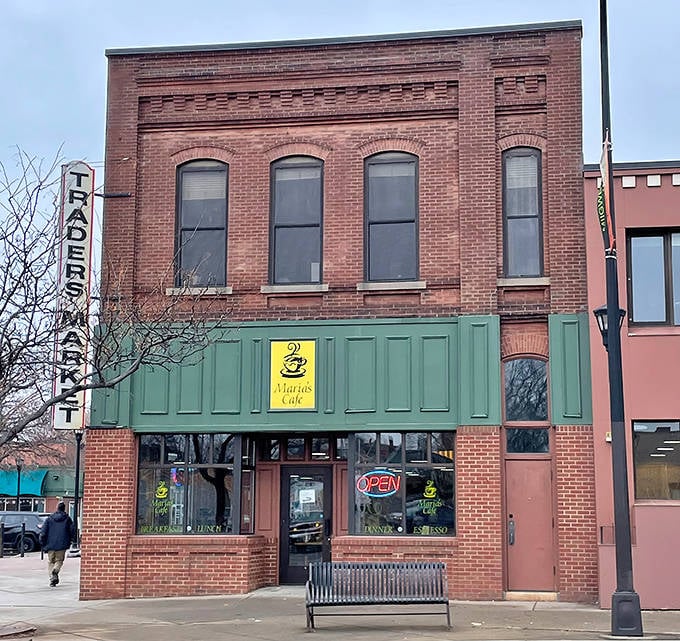 Maria's Café's brick exterior with its distinctive green awning stands as a culinary landmark on Franklin Avenue, beckoning hungry passersby with promises of Colombian delights.