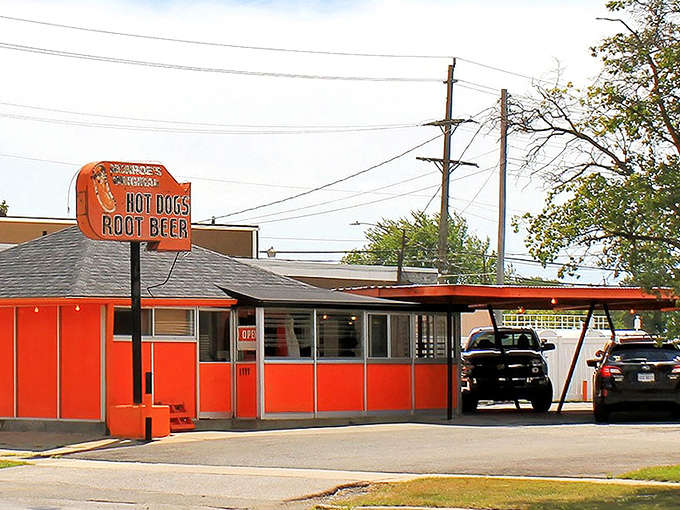 Monroe's Original Hot Dog Drive-In stands proudly in its bright orange glory, a time capsule of American drive-in culture serving Monroe's finest since forever.