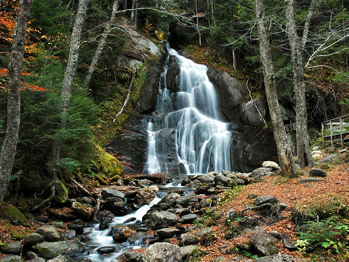 Nature's perfect cascade moment &ndash; Moss Glen Falls tumbles gracefully through autumn-kissed forest, proving Vermont doesn't need filter apps to look this good.