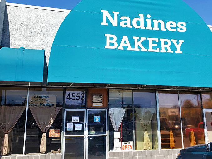 The iconic turquoise awning of Nadine's Bakery stands as a beacon of sweetness on Broadway Boulevard, promising delectable treasures within.