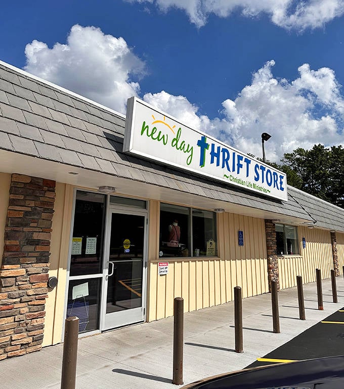 The welcoming facade of New Day Thrift Store in Little Canada beckons bargain hunters with its cheerful sign against Minnesota's big blue sky.