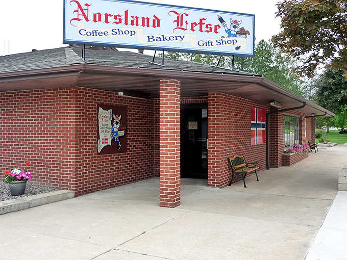 The iconic Norsland Lefse storefront in Rushford welcomes visitors with its charming brick exterior and friendly Viking mascot.