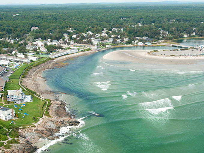 Nature's masterpiece unfolds where emerald forests meet turquoise waters, creating Maine's most picturesque seaside panorama.