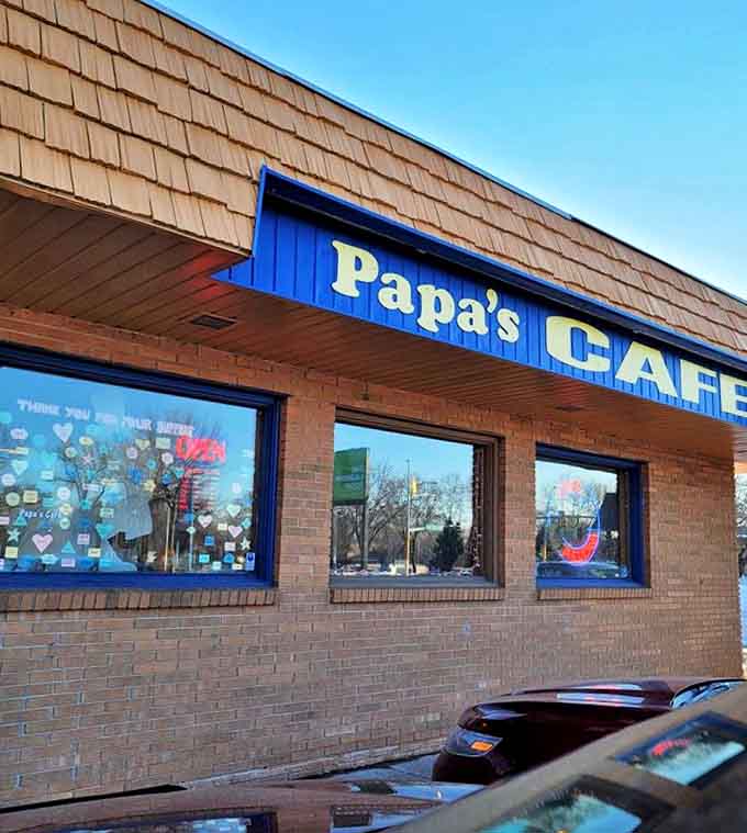 Papa's Cafe exterior beckons with its bright blue trim and vintage signage &ndash; a humble facade hiding breakfast greatness within.