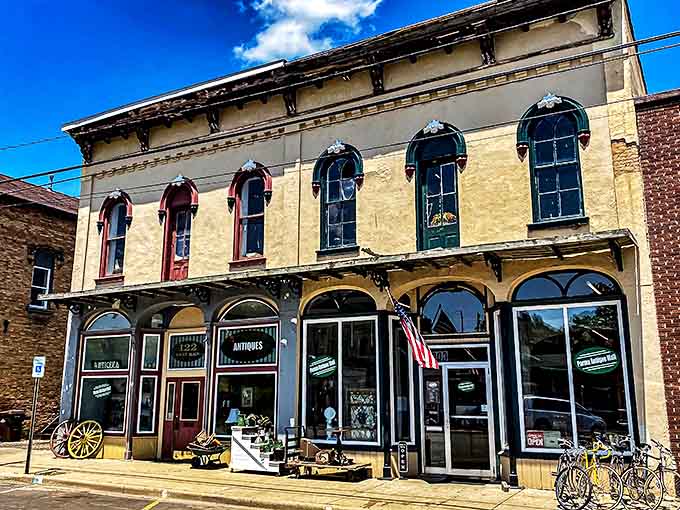 The stately yellow facade of Parma Antique Mall stands like a time portal on Main Street, its historic windows offering glimpses of treasures within.