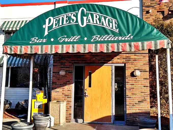 The iconic green awning of Pete's Garage beckons hungry travelers like a lighthouse for flavor-seekers on Telegraph Road in Monroe.