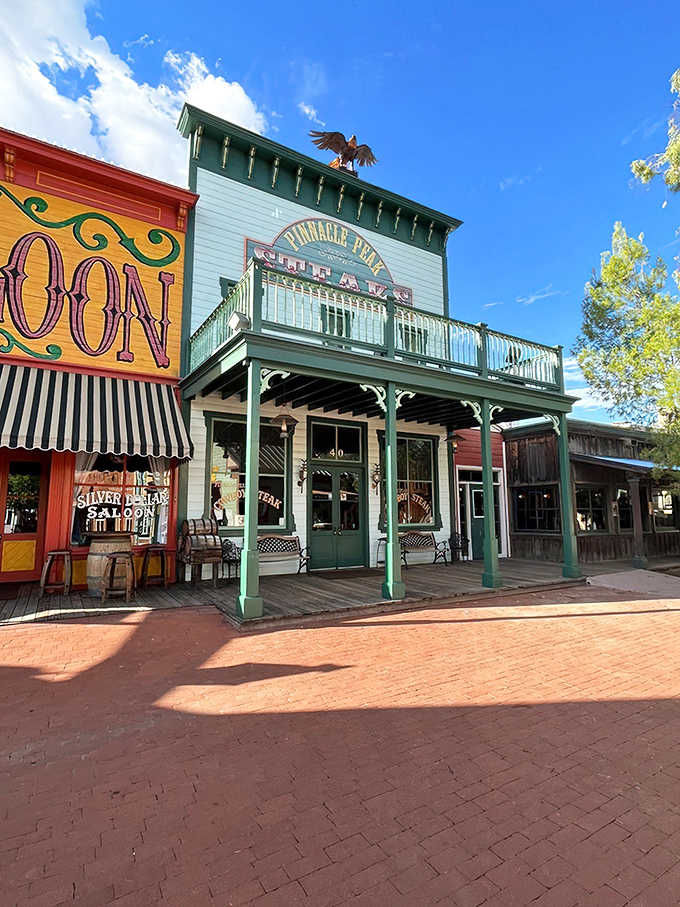 Pinnacle Peak's iconic green facade welcomes visitors with Old West charm, complete with a wooden eagle perched proudly on top.