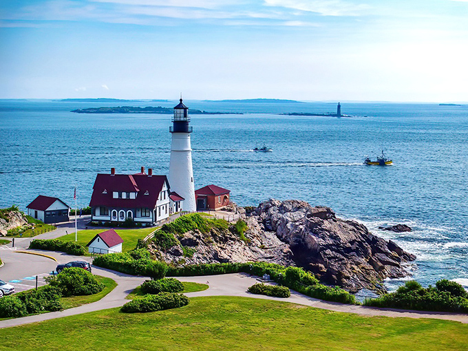 Portland Head Light stands majestically against the Atlantic backdrop, its white tower and red-roofed keeper's quarters creating the quintessential Maine postcard moment.