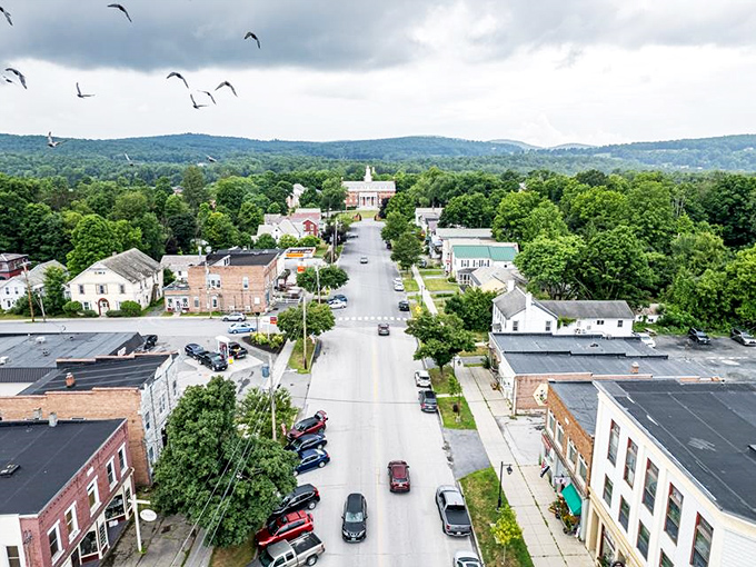 Poultney's main street stretches toward the horizon, where church steeples punctuate the skyline against a backdrop of Vermont's rolling hills.