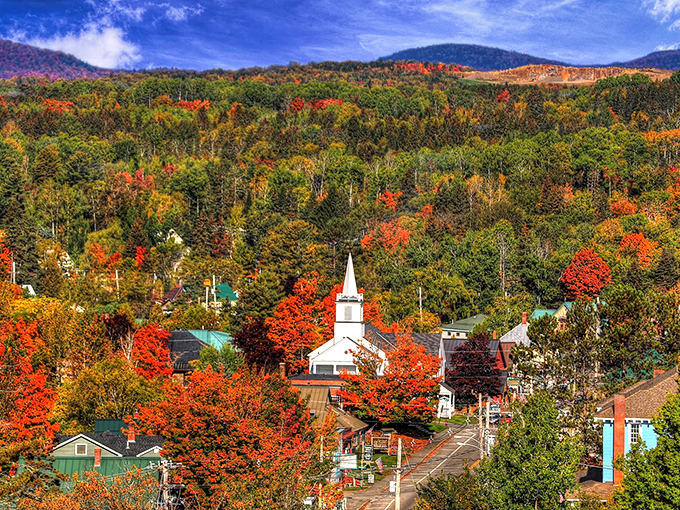 Rangeley's church steeple pierces a canvas of autumn foliage, like a postcard that somehow captures the scent of crisp mountain air.